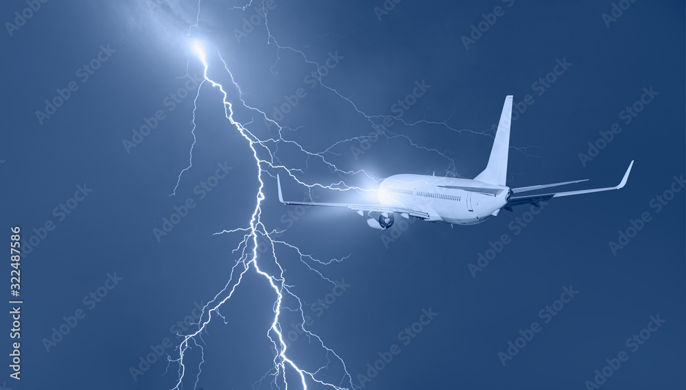 Airplane in the sky with thunder and lightning Stock Photo | Adobe Stock