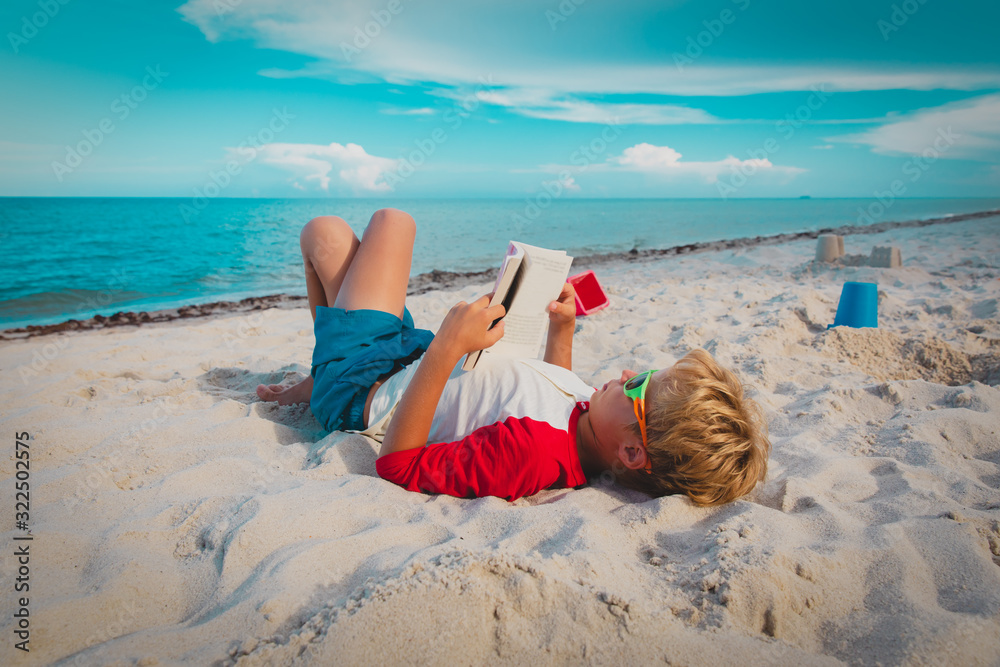 boy reading book at sand beach, kid learning on vacation Stock Photo ...