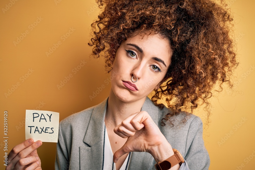Young business woman with curly hair holding pay taxes to goverment ...