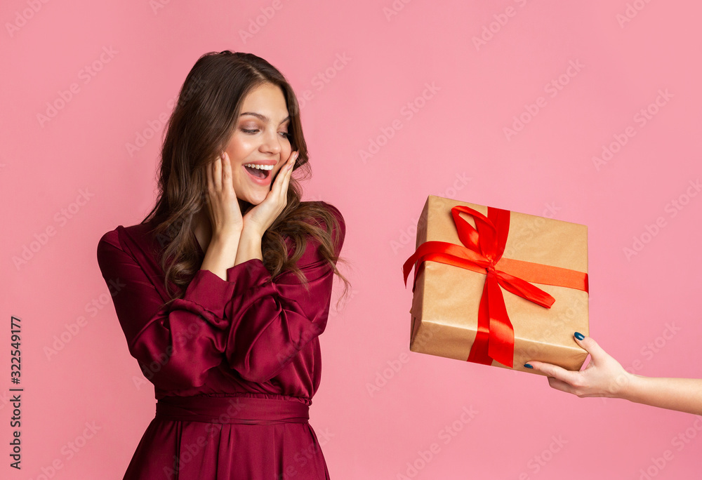 Excited young woman in evening dress getting surprise gift box Stock ...