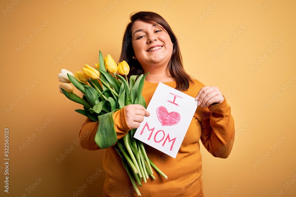 Young beautiful plus size woman celebrating mothers day holding love ...