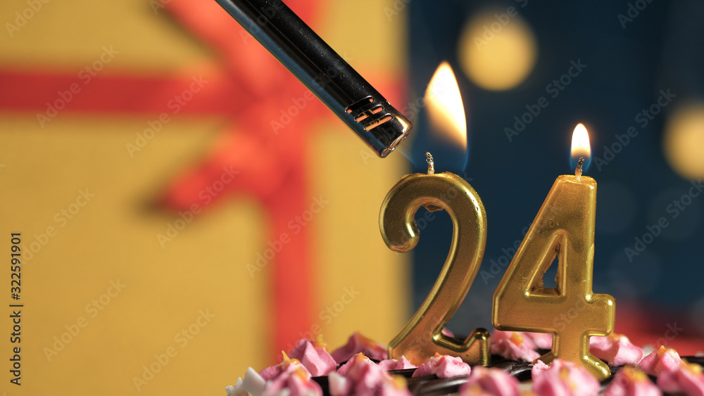 Birthday cake number 24 golden candles burning by lighter, background ...