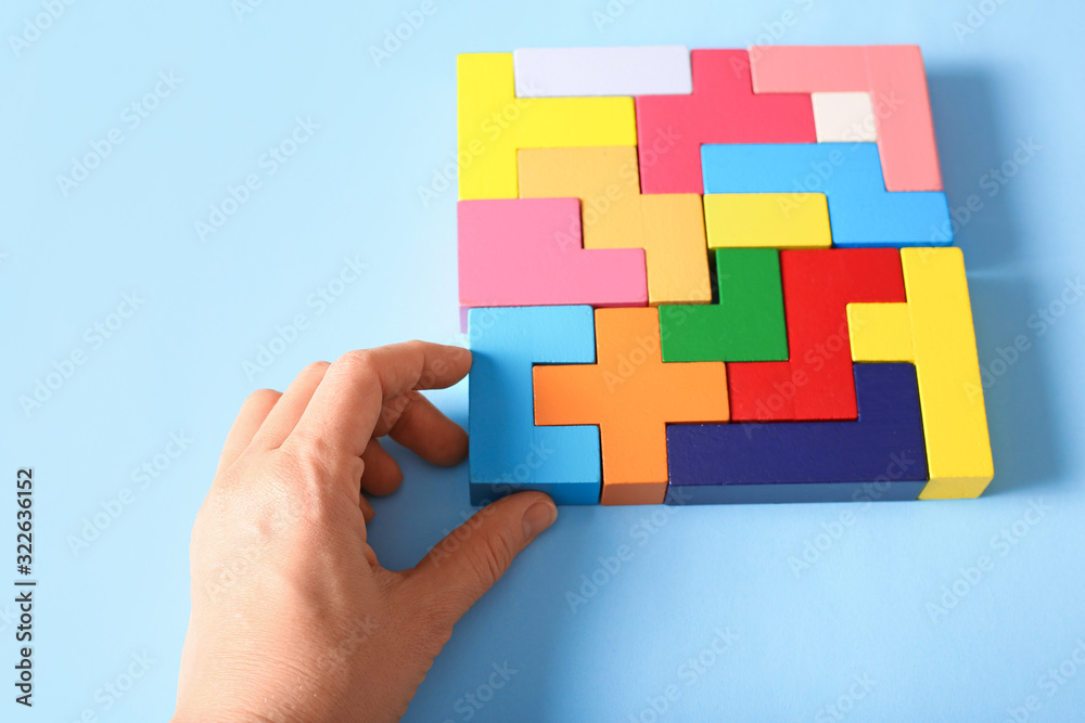 Wooden tangram cubes as a symbol of riddle Stock Photo | Adobe Stock