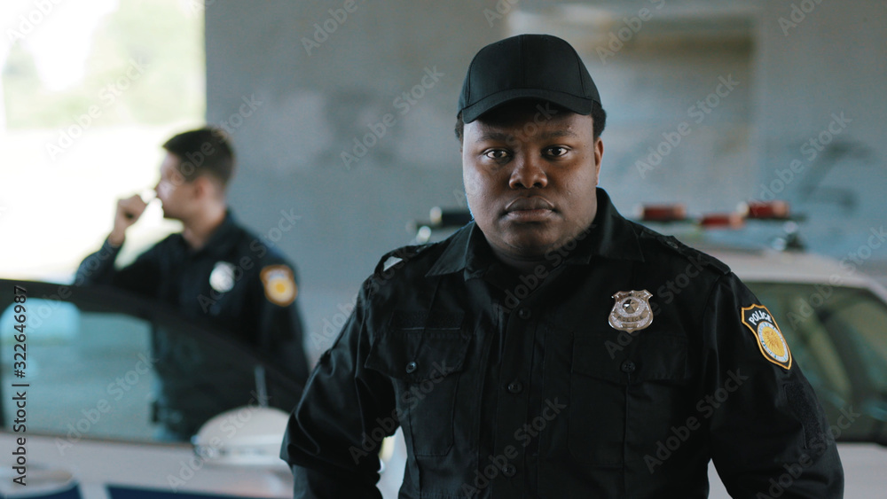 Portrait serious african american young man wear uniform cops stand ...