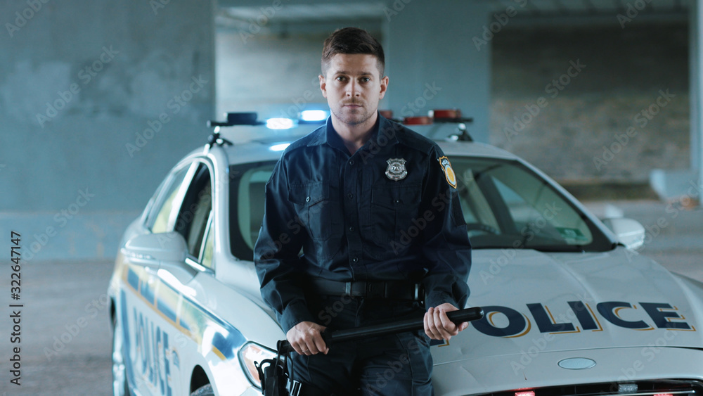 Handsome young man cops stand near patrol car look at camera around ...