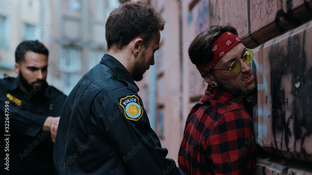 Slow motion policeman with pistol arrest robber in handcuffs standing ...