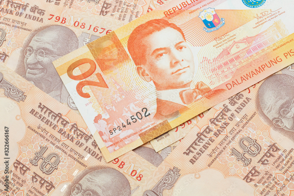 An orange twenty piso bank note from the Philippines with Indian ten ...