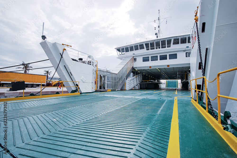 Ferryboat loading or unloading by a port pier. Concept of ...