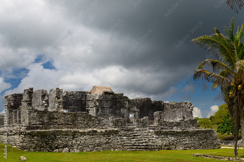 Temple of the Descending God at Tulum Mexico with storm cloud and ...