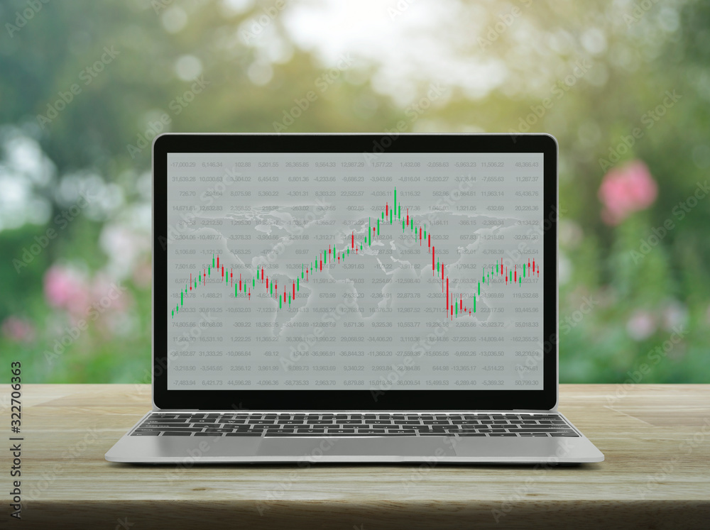 Trading graph of stock market with world map and graph on modern laptop ...