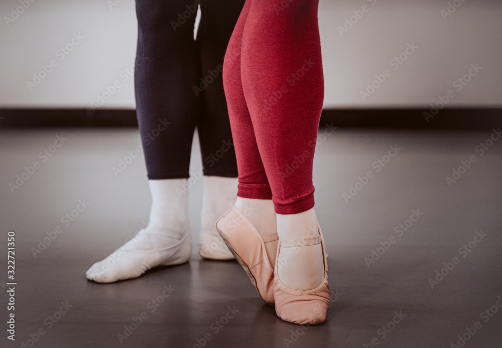 Male and female ballet dancers, standing, first position and quatrieme ...