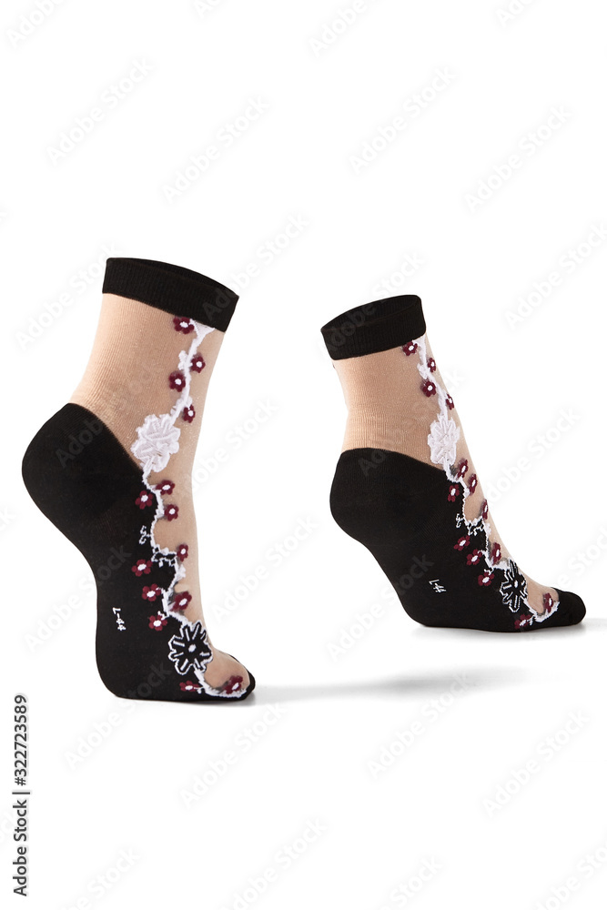 Cropped shot of female feet on tiptoe in flesh-colored nylon sheer ...