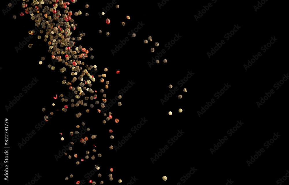 Whole coloured pepper spice flying in the air close up. Zero gravity ...