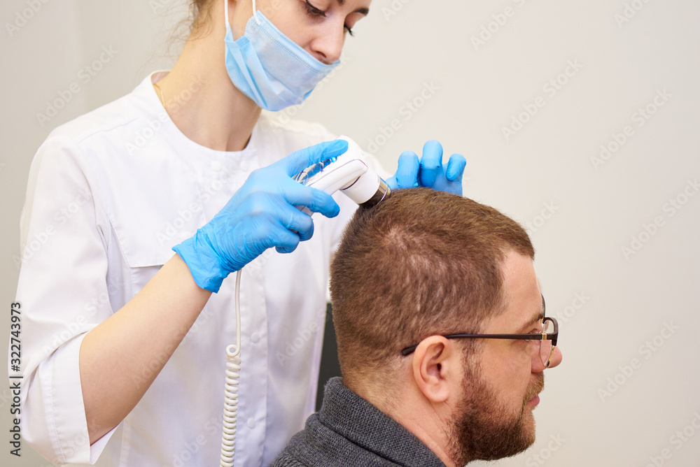Microscopic examination of the hair and skin of the scalp. Stock Photo ...