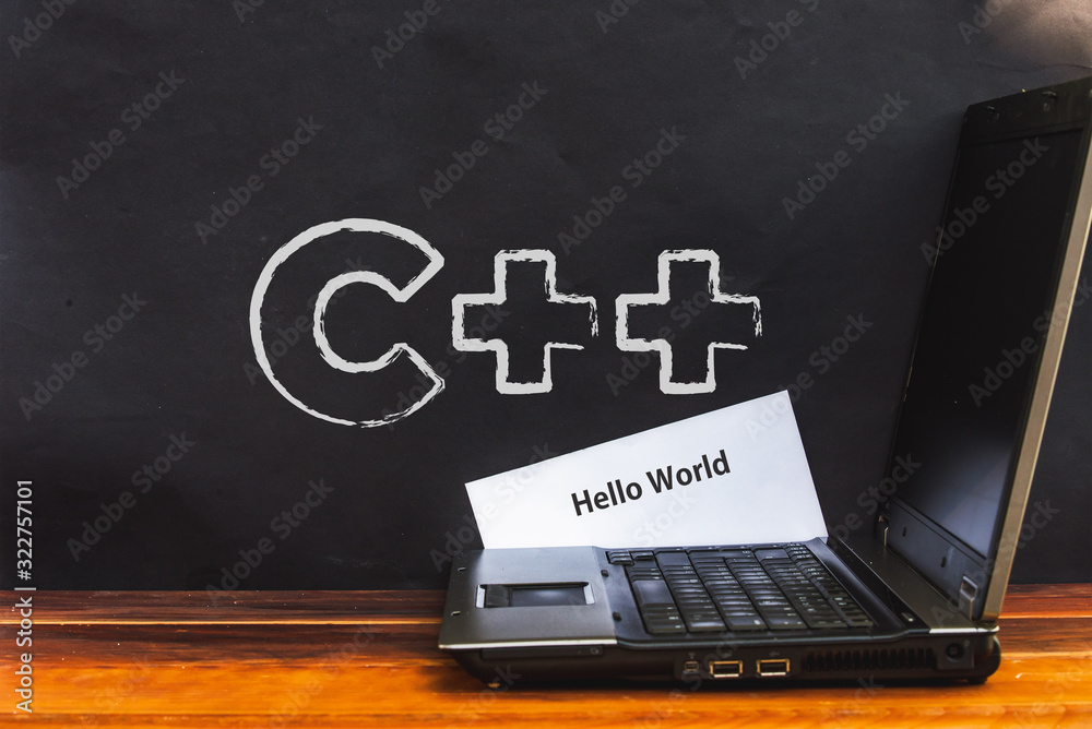 Foto de C++ programming language. Laptop and c++ on dark wall do Stock ...