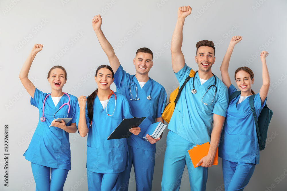 Group of happy medical students on light background Stock Photo | Adobe ...