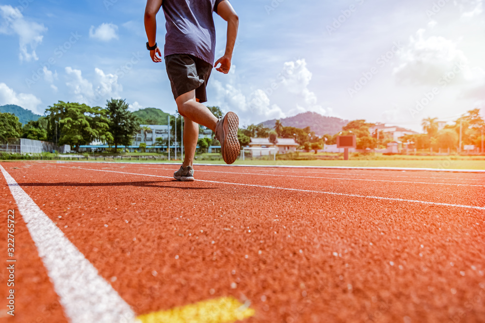 Sport Man jogging and running on track race at Stadium.Sport concept ...