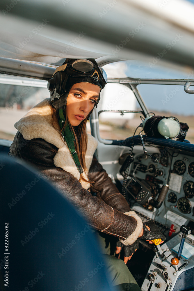 close-up of a pilot s girl in the cockpit of an airplane with a ...