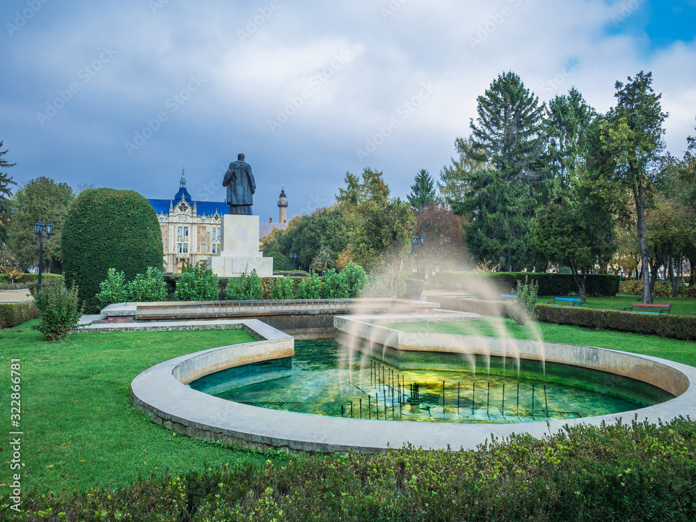 Central park of Satu Mare in springtime and historic statue of Vasile ...