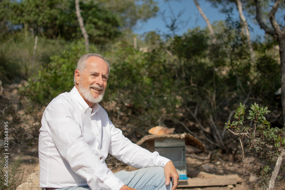 Old man sitting enjoying life in nature Stock Photo | Adobe Stock