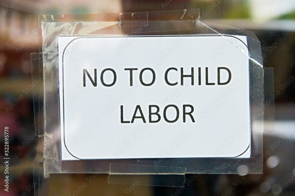 Photocopied sign with 'No To Child Labor' posted on an entrance glass ...