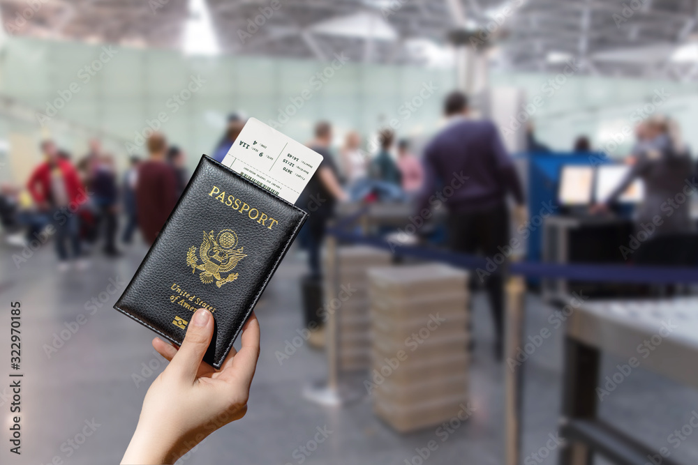 Woman hand holding american passport with boarding pass in the airport ...