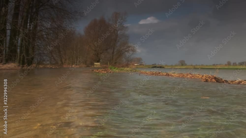 Water running over the floodplains of the river IJssel during flooding ...