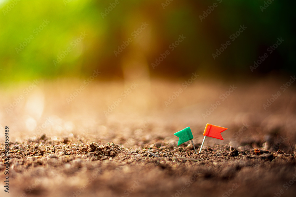 green and red push pin flag marking a location on the arid ground ...
