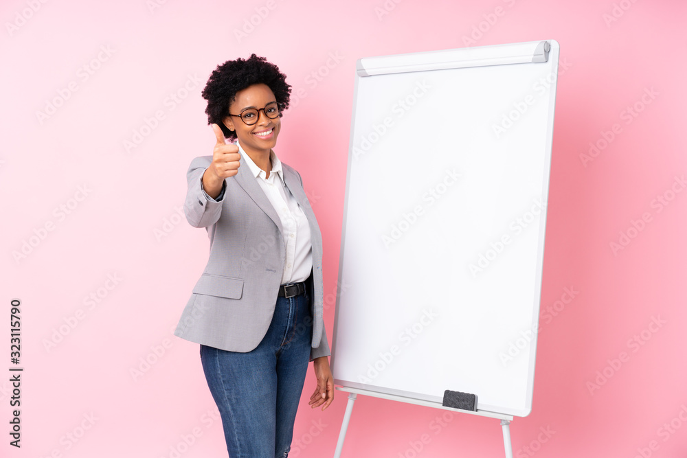 African american business woman giving a presentation on white board ...