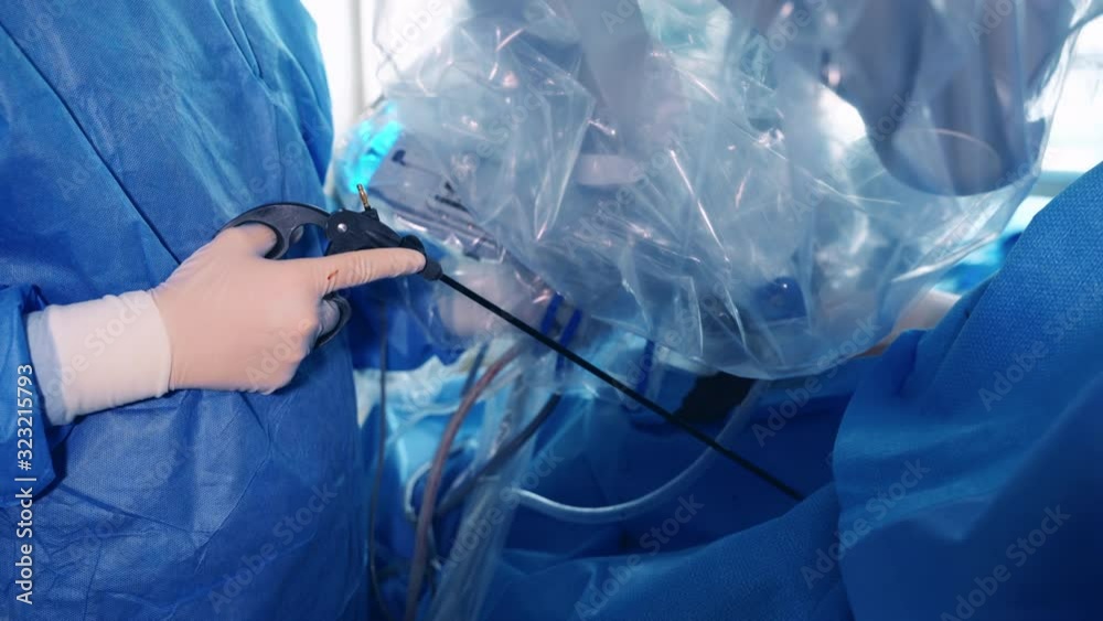 Surgeon operates robotic device in operating room. Modern medical ...