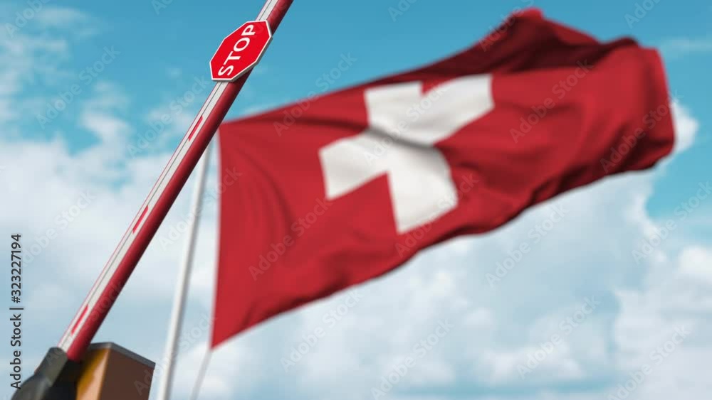 Opening boom barrier with stop sign against the Swiss flag. Free border ...