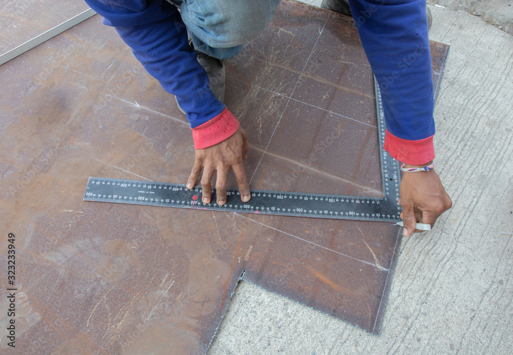 A white stone chalk positioned with yellow color measure tape is in the ...