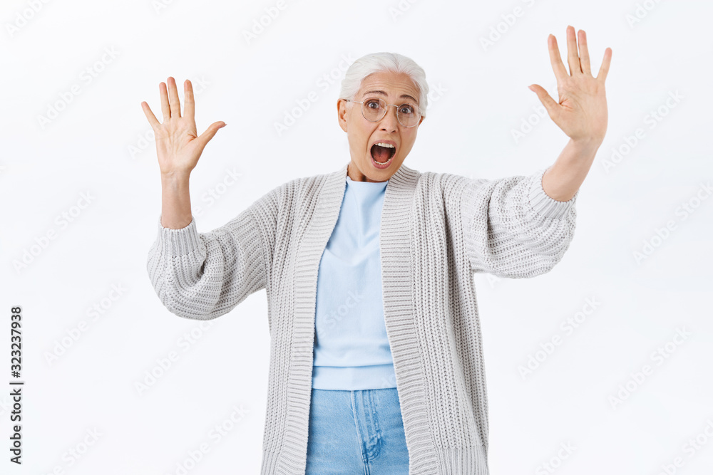 Scared and shocked old lady being frightened by grandchild jumping from ...