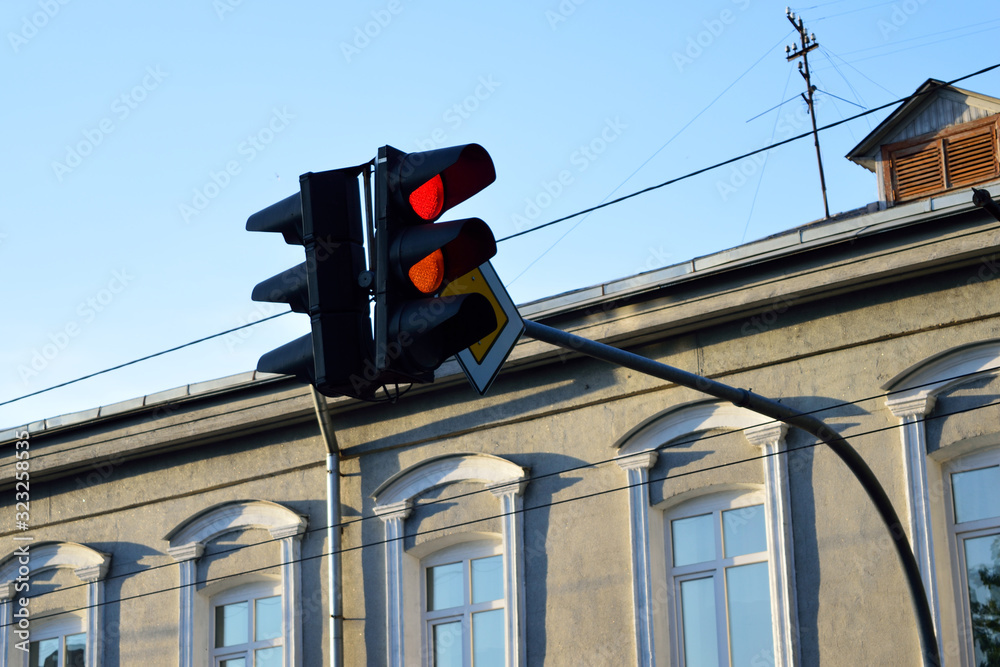Street traffic light with red and yellow light on the background of the ...