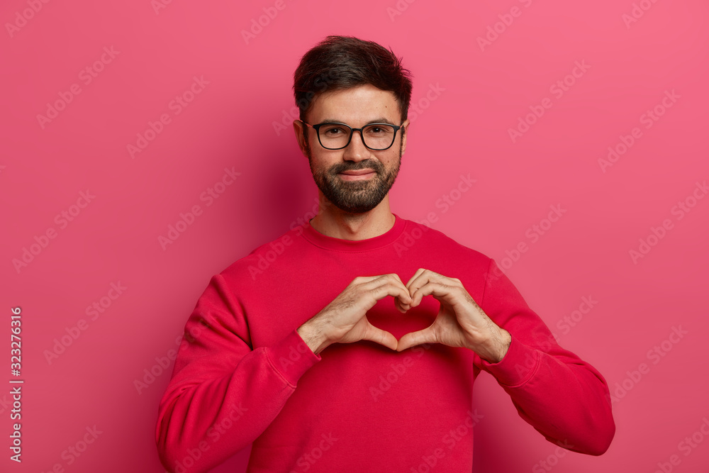 My heart belongs to you. Romantic handsome bearded man makes heart ...