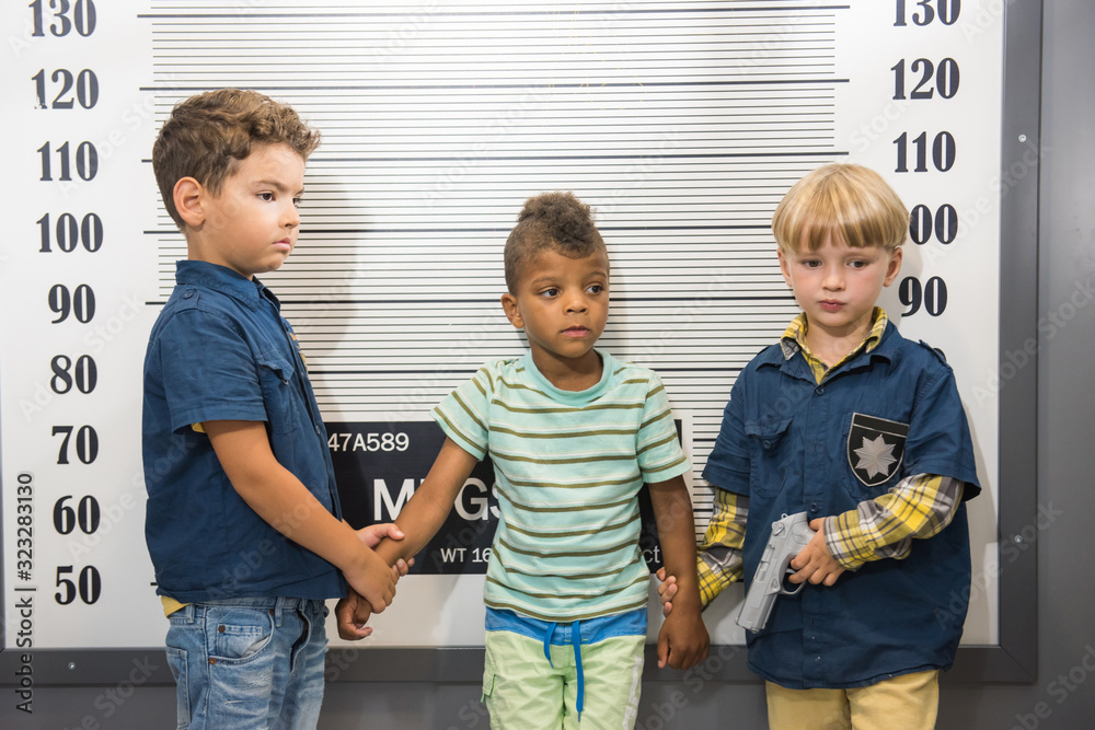 Childrens role play center. Little boys playing police and thief indoor ...