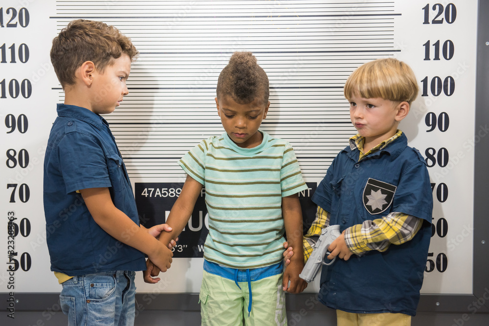 Role play at the game center for children. Boy criminal in prison in ...
