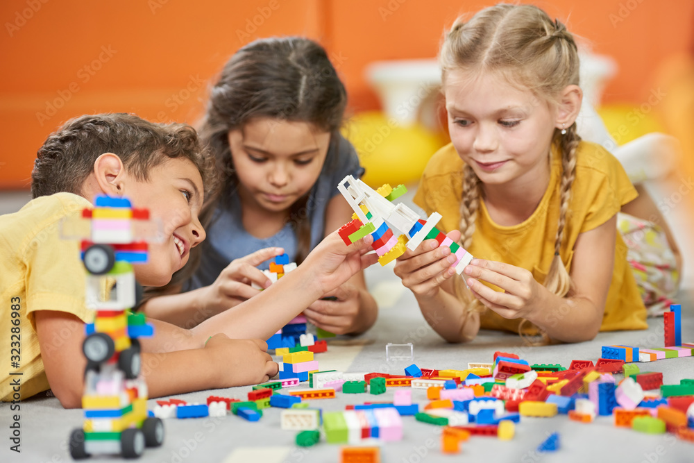 Group of kids playing with plastic blocks. Children playing with ...