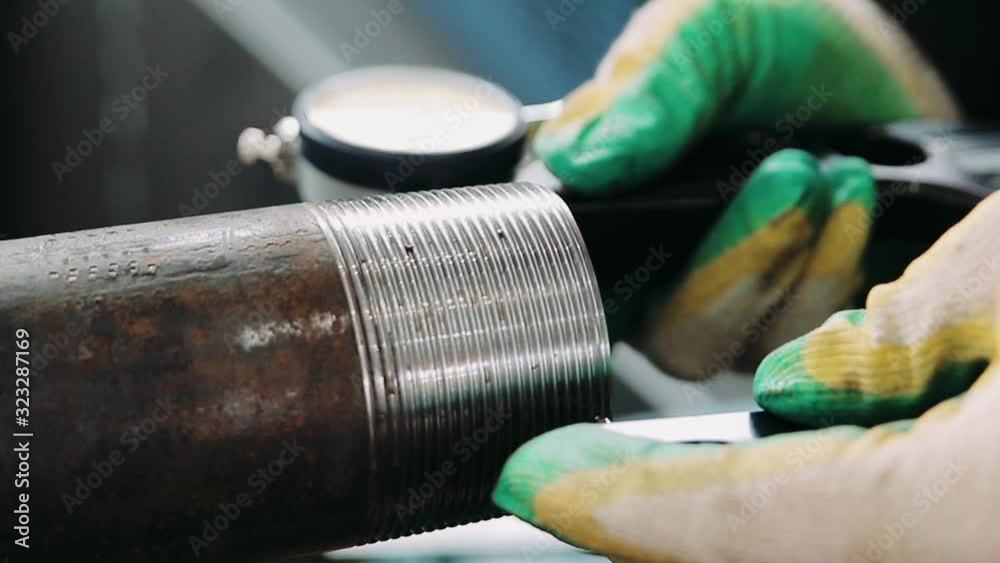Quality control of Drill pipe production at factory. Checking accuracy ...