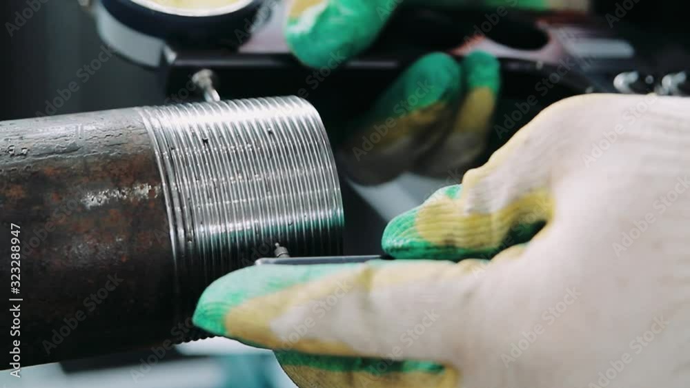 Quality control of Drill pipe production at factory. Checking accuracy ...
