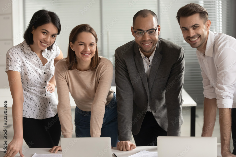 Smiling diverse colleagues posing for picture at workplace Stock Photo ...