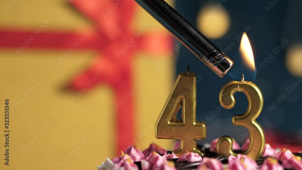 Birthday cake number 43 golden candles burning by lighter, blue ...