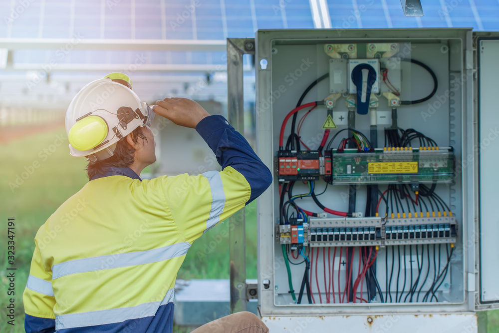 Young engineers who are expert in solar power generation systems ...