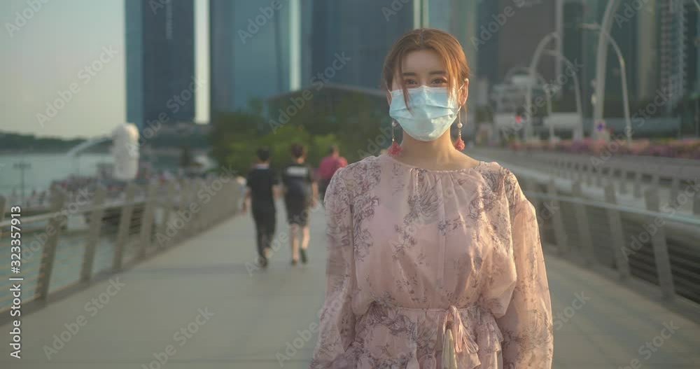 Asian Chinese girl wearing a surgical face mask to protect herself from ...