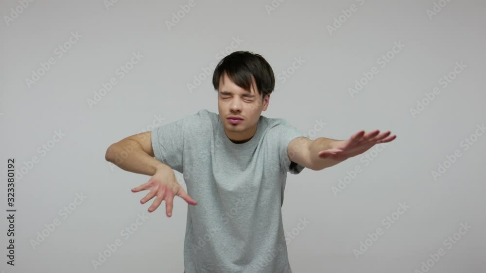 Blindness, lost way. Disoriented young guy in T-shirt walking with ...