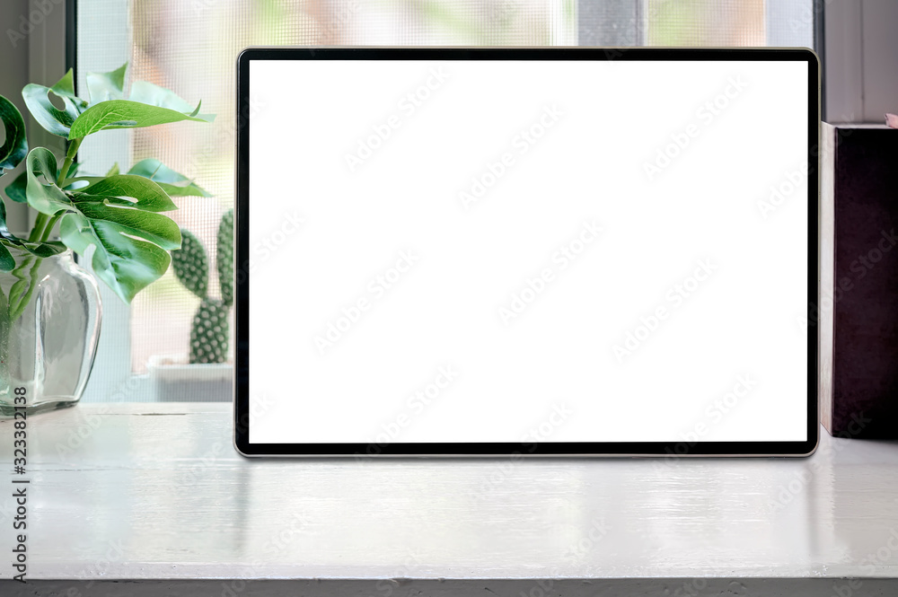 Mockup blank screen tablet with houseplant and book on white wooden ...