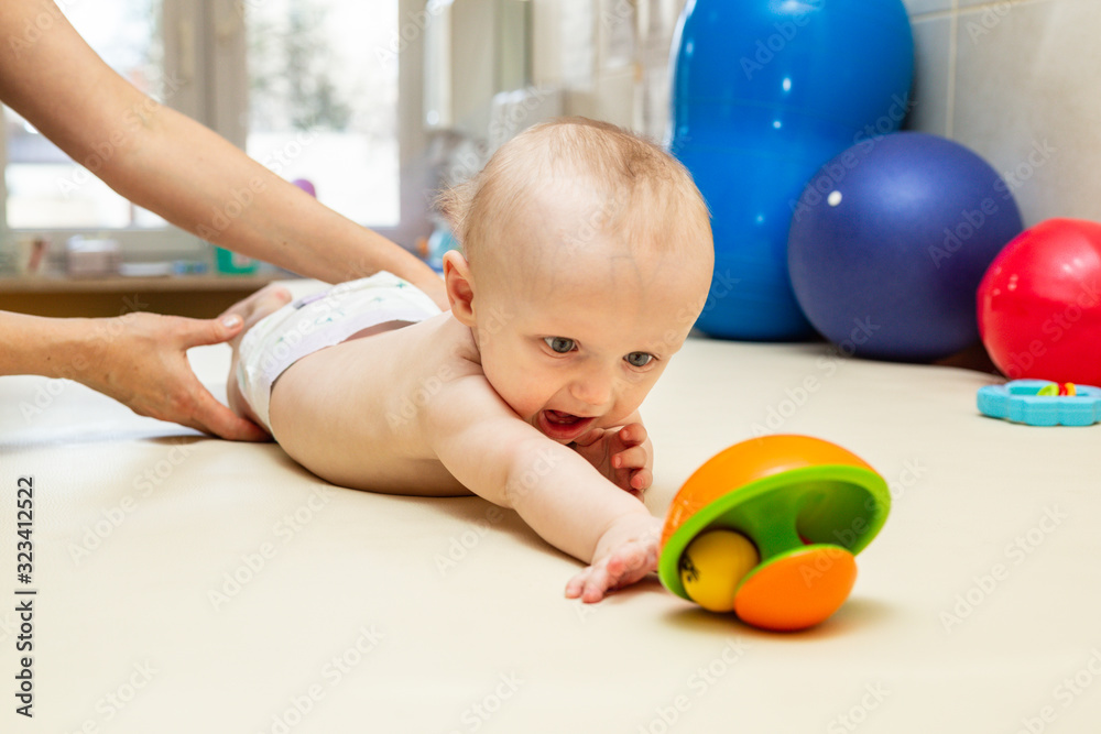Pediatric Physical Therapy - an infant exercising on a table Stock ...