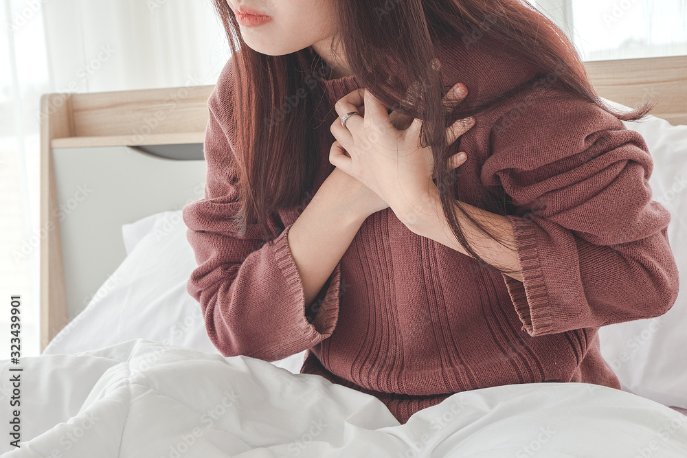 Young woman in pajamas having heart attack,Heart attack. Young woman ...