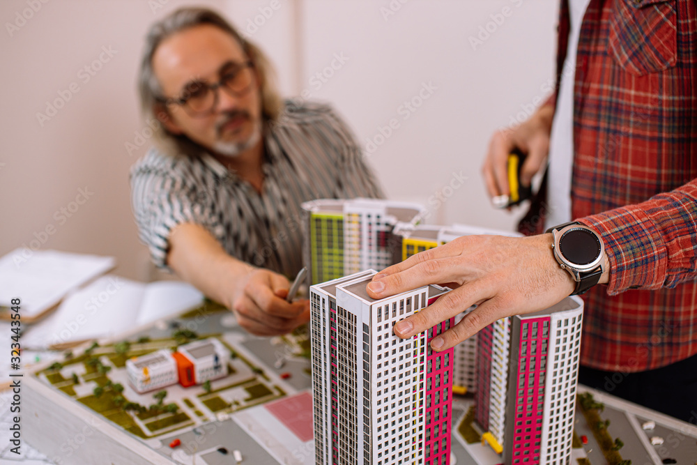 experienced caucasian architect and young future foreman in office ...