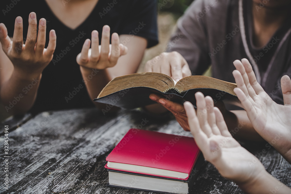 Foto de Group of different women praying together do Stock | Adobe Stock